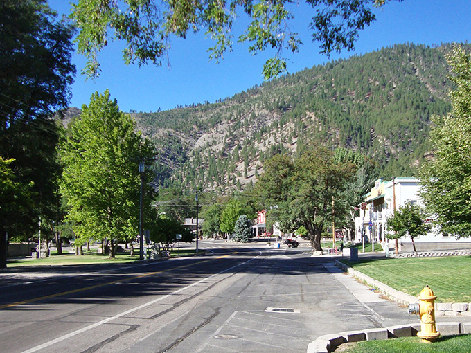 Genoa's main street offers that perfect small-town tableau – historic buildings nestled against mountains so majestic they look like they're showing off.
