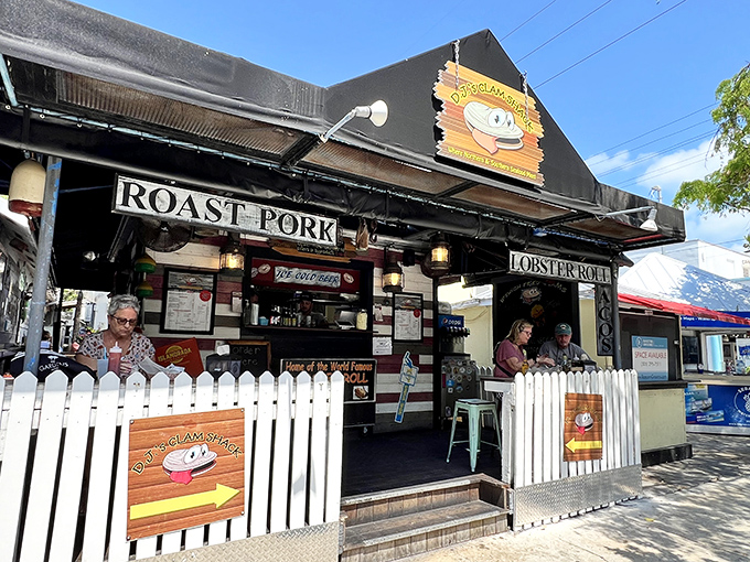 The white picket fence isn't keeping anyone out—it's corralling hungry seafood lovers into this Key West treasure where lobster rolls and happiness await.