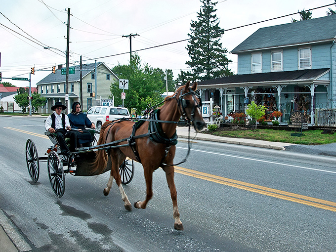 Where horse-drawn buggies and modern vehicles share the road in perfect harmony. A typical scene in Intercourse, where time moves at its own gentle pace.