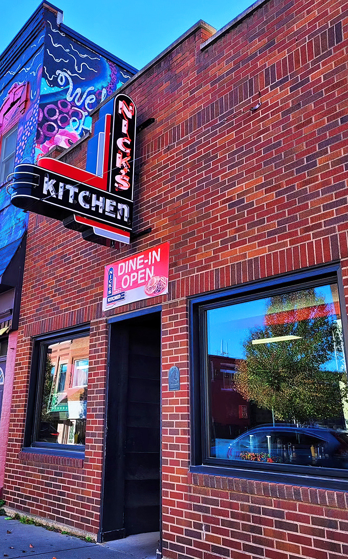 The iconic neon sign of Nick's Kitchen stands as a beacon of culinary history on Huntington's Jefferson Street. A century of tenderloin tradition lives behind this brick façade.