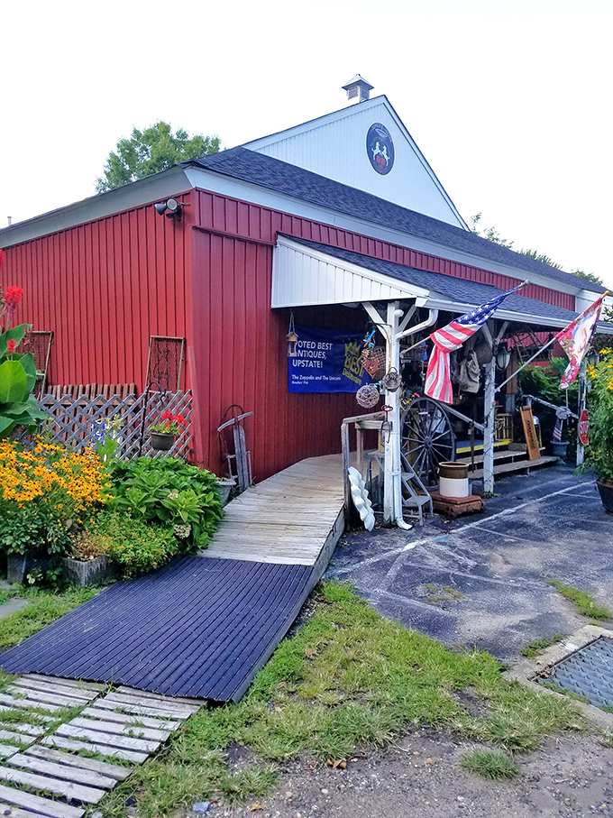 The red barn exterior of The Zeppelin and The Unicorn beckons like a portal to another time. Vibrant flowers and vintage flags hint at the treasures within.
