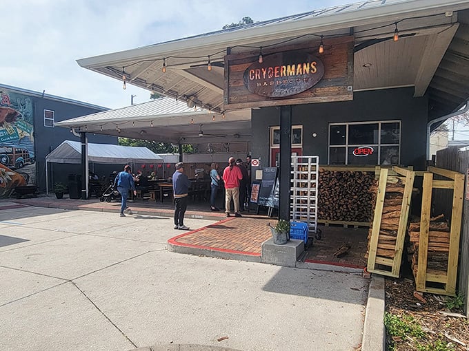 The unassuming exterior of Crydermans hides barbecue greatness like a superhero's secret identity. Stacked firewood isn't decor—it's a promise of smoky deliciousness to come.