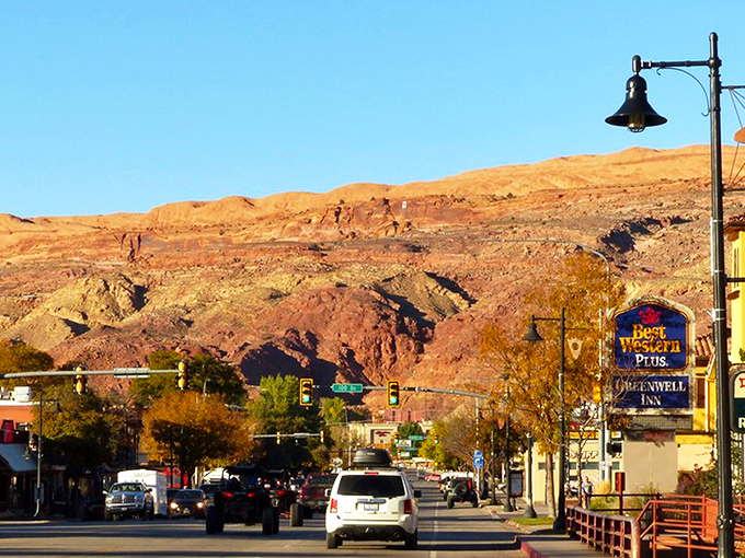 Main Street Moab, where pickup trucks are the fashion statement and those red rock backdrops aren't painted—Mother Nature just showing off.
