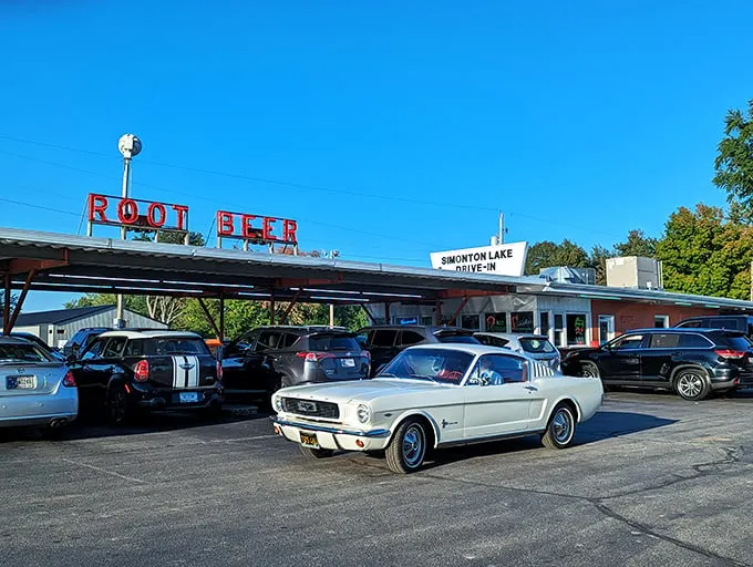 The classic neon "ROOT BEER" sign glows like a beacon to hungry travelers, promising nostalgic flavors under the Indiana sky.