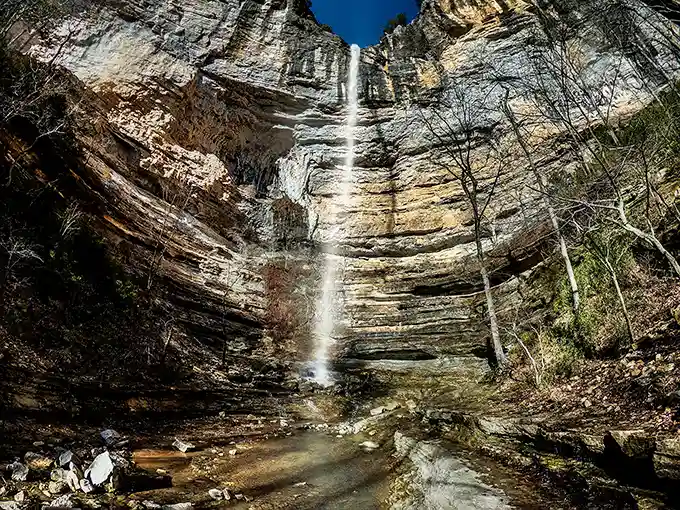 Nature's skyscraper in reverse – Hemmed-In Hollow's 209-foot cascade plummets down layered limestone cliffs, creating a spectacle worth every step of the journey.