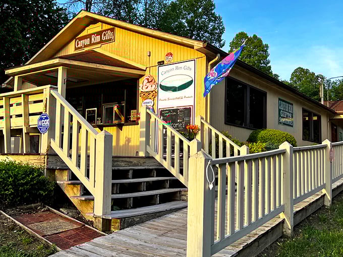 The sunny yellow exterior of Canyon Rim Gifts beckons travelers like a folksy lighthouse amid the West Virginia mountains, promising treasures within.