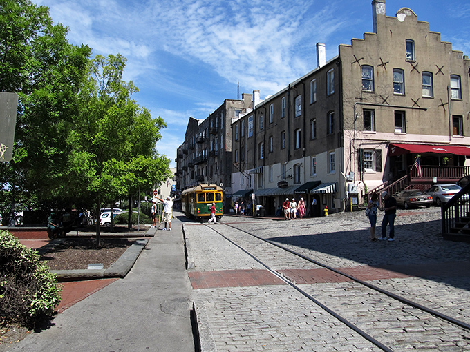 Savannah's historic district, where cobblestone streets and trolley tracks remind you that some places refuse to surrender their charm to modern inconveniences.