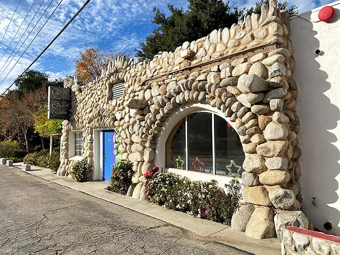 Stone by stone, this fairy tale façade promises culinary magic within. The blue door isn't just an entrance—it's a portal to France itself.