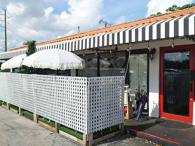 The black and white striped awning and bright red door of La Fresa Francesa isn't just charming—it's like Paris decided to vacation in Hialeah and never left.
