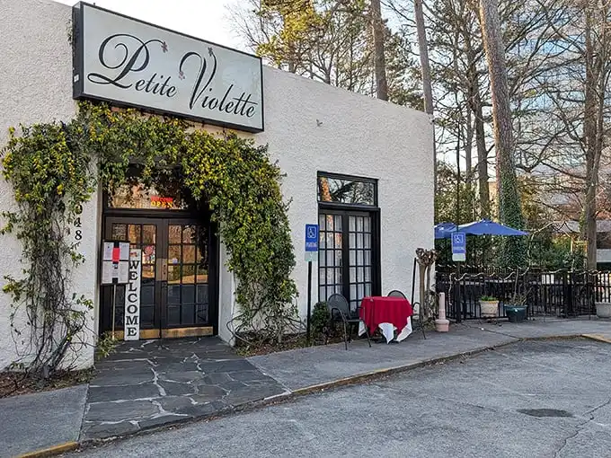 The ivy-draped entrance to Petite Violette beckons like a secret French hideaway. One step through those doors and Atlanta disappears behind you.