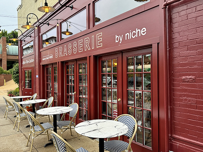 The burgundy façade beckons like a Parisian street corner transplanted to St. Louis, complete with those quintessential French bistro tables waiting for your arrival.