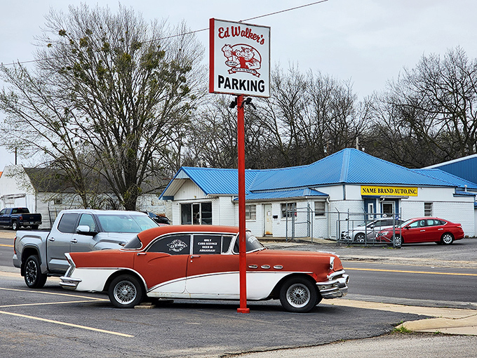 The classic red and white Buick parked outside isn't a prop—it's just another day at Ed Walker's, where time stands deliciously still.
