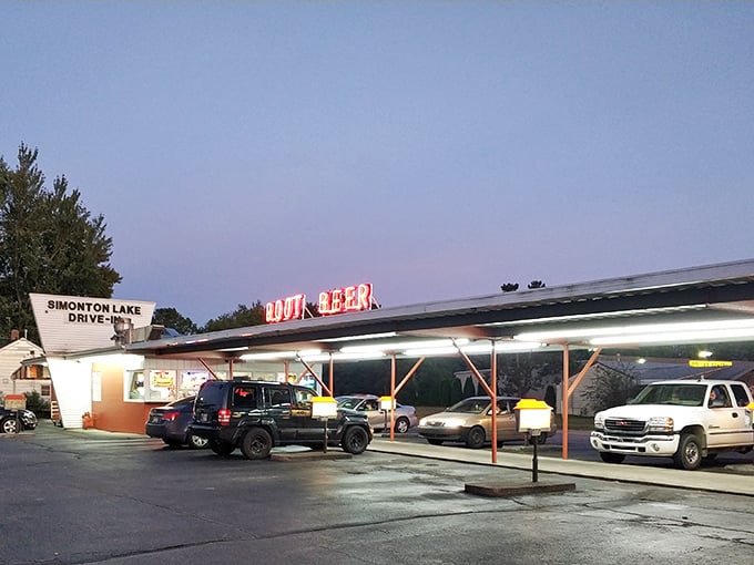 The classic neon "ROOT BEER" sign glows like a beacon to hungry travelers, promising nostalgic flavors under the Indiana sky.