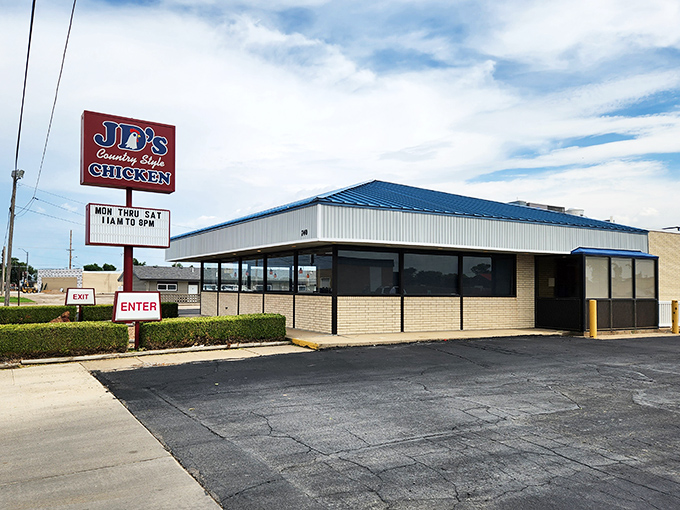 The iconic red and blue sign of J.D.'s Country Style Chicken stands as a beacon for hungry travelers along the highway in Hays, Kansas.