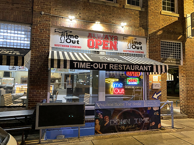The brick facade of Time-Out beckons hungry visitors with its iconic striped awning and neon signs—a 24/7 beacon of Southern comfort on Franklin Street.