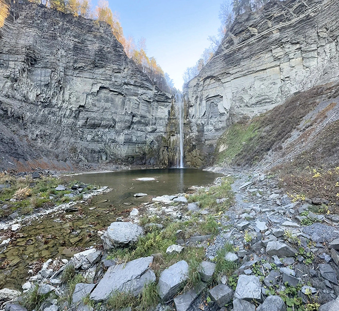 Mother Nature's grand amphitheater features a 215-foot waterfall plunging into a limestone basin—proof that New York's most impressive skyscrapers aren't all in Manhattan.