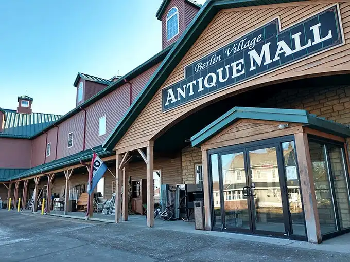 The rustic exterior of Berlin Village Antique Mall stands like a time portal in Ohio's Amish Country, promising treasures within its weathered wooden walls.