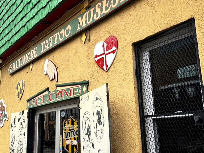 The emerald-shingled building stands out like a peacock at a pigeon convention, its vibrant yellow base and tattoo-adorned façade announcing something wonderfully different awaits inside.