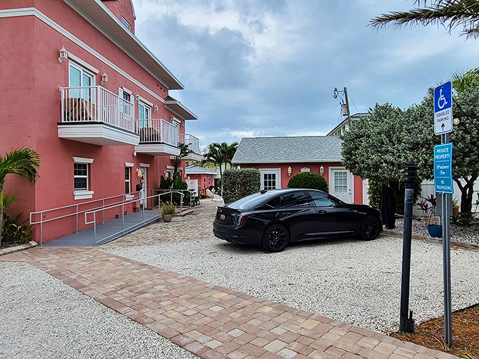 The coral-pink façade of Windermere Inn by the Sea stands like a blushing debutante against Florida's blue sky, promising coastal comfort with every white-trimmed window.