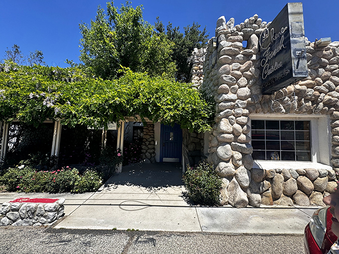 Stone by stone, this fairy tale façade promises culinary magic within. The blue door isn't just an entrance—it's a portal to France itself.