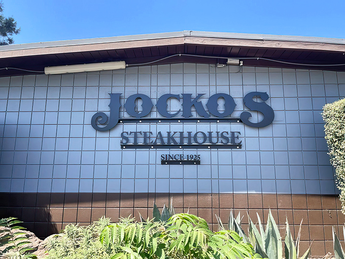 The unassuming exterior of Jocko's belies the culinary magic within. Like finding a treasure chest disguised as a shoebox, this modest façade hides California's steak paradise.