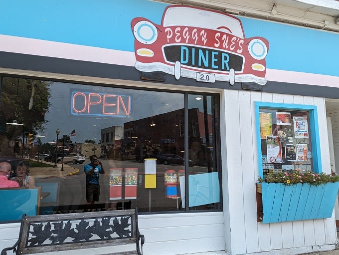 Welcome to Peggy Sue's, where the blue awning beckons like a retro beacon of breakfast bliss. Step inside and prepare for a time-warp to deliciousness!