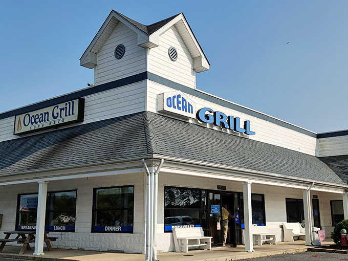 The white clapboard exterior of Ocean Grill stands like a beacon of comfort food promise. Those nautical round windows aren't just for show—they're portals to flavor town. 
