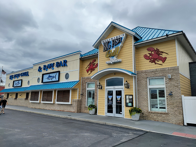 The cheerful yellow exterior with its signature blue roof stands like a maritime beacon, promising seafood treasures within Wilmington's revitalized Riverfront district.