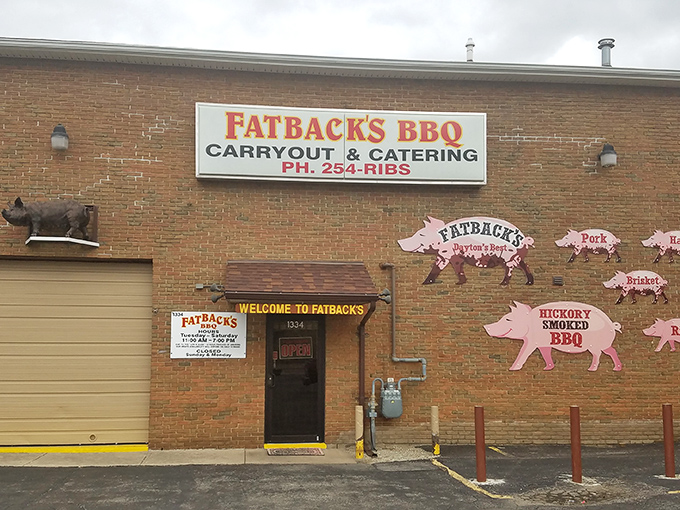 The pink pig silhouettes on Fatback's brick exterior aren't just decoration—they're a roadmap to flavor paradise. Welcome to pork heaven!