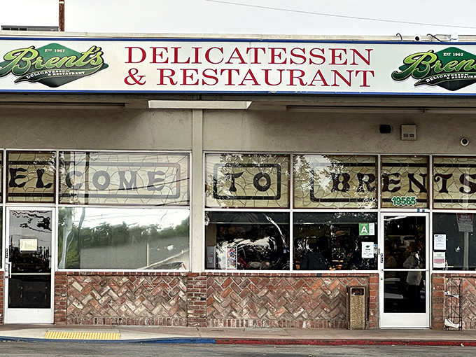 The classic storefront of Brent's Deli beckons with its nostalgic charm. Those red umbrellas aren't just for show—they're gateways to sandwich paradise.