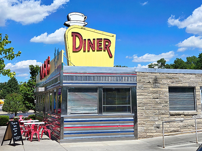 The sunshine-yellow facade of Oasis Diner gleams like a beacon of hope for hungry travelers. This isn't just a restaurant—it's a time machine with french fries.