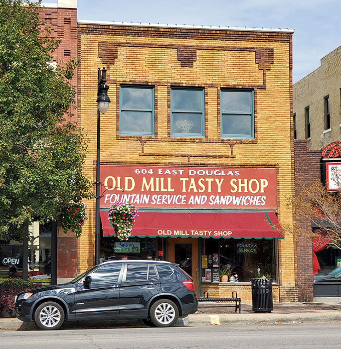 The yellow-brick storefront with its vintage red awning isn't just preserving history—it's practically a time portal to 1932 Wichita with better sandwiches.