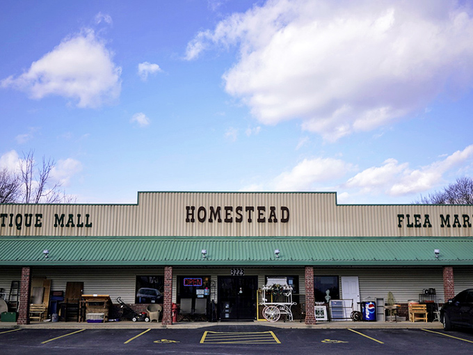 The unassuming exterior of Homestead Antique Mall belies the treasure trove within—like finding a portal to the past disguised as a strip mall storefront.