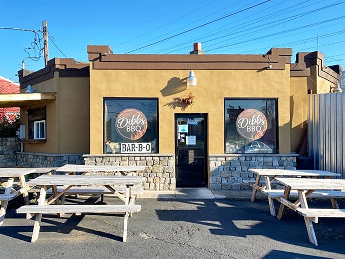 The modest yellow exterior of Dibbs BBQ doesn't scream for attention, but those colorful pennants are like smoke signals beckoning hungry travelers to barbecue paradise.