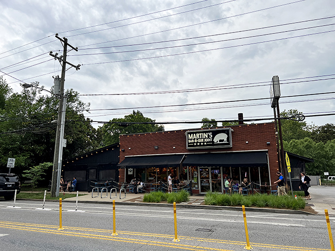 The red brick exterior of Martin's Bar-B-Que Joint beckons hungry pilgrims with its no-nonsense façade and the promise of smoky delights within.