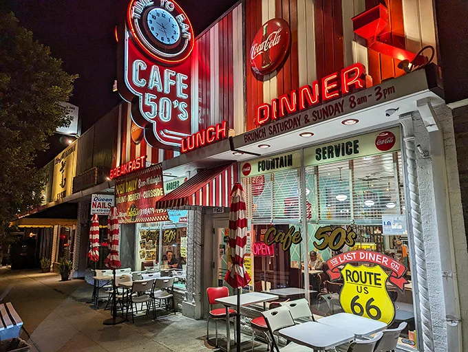 The neon glow of Cafe 50's beckons like a time machine disguised as a diner. Route 66 nostalgia never tasted so good.