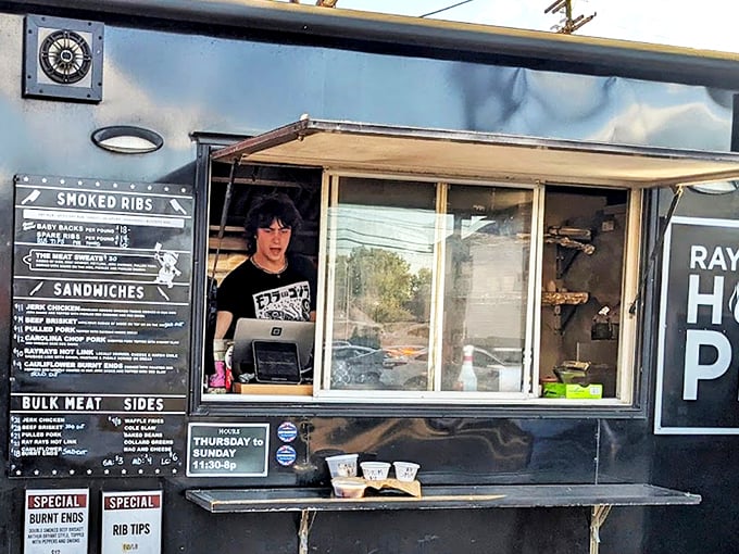 The black food truck of destiny stands ready, its "RAY RAY'S HOG PIT" sign a beacon to barbecue pilgrims seeking smoky salvation in Columbus.