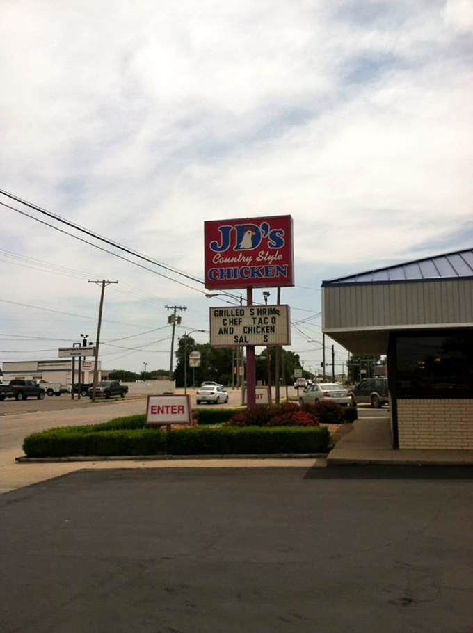 The iconic red and blue sign of J.D.'s Country Style Chicken stands as a beacon for hungry travelers along the highway in Hays, Kansas.