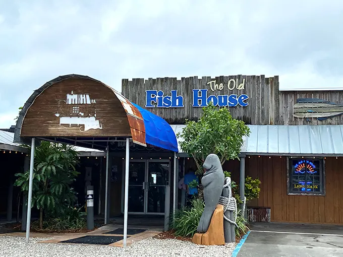 The weathered wooden exterior and giant fish sculpture aren't trying to impress you—they're saving all that energy for what's on your plate.