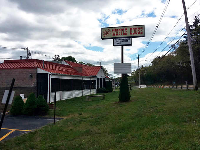 The iconic Vic's Waffle House sign stands tall against the Massachusetts sky, beckoning hungry travelers with promises of breakfast bliss and maple-drenched dreams.