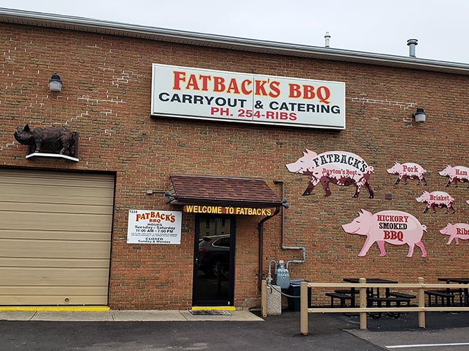 The pink pig silhouettes on Fatback's brick exterior aren't just decoration—they're a roadmap to flavor paradise. Welcome to pork heaven!