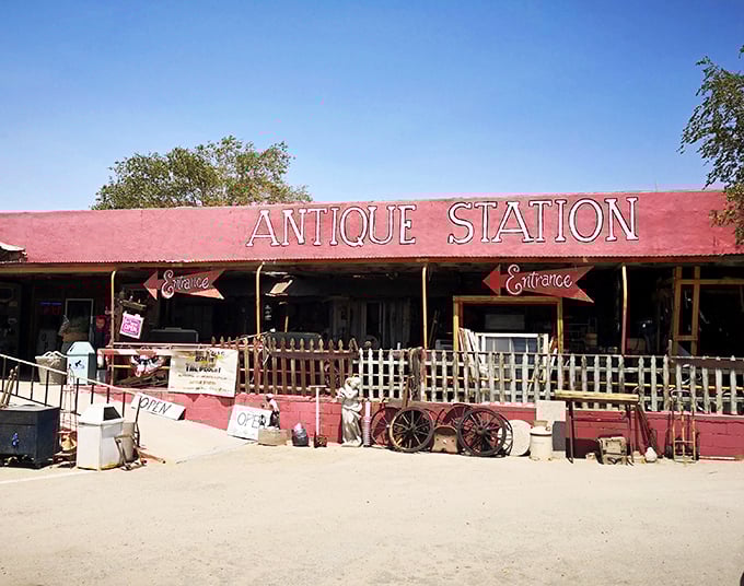 The desert sky creates a perfect backdrop for Antique Station's vibrant red façade. Route 66 charm doesn't get more authentic than this roadside treasure trove.