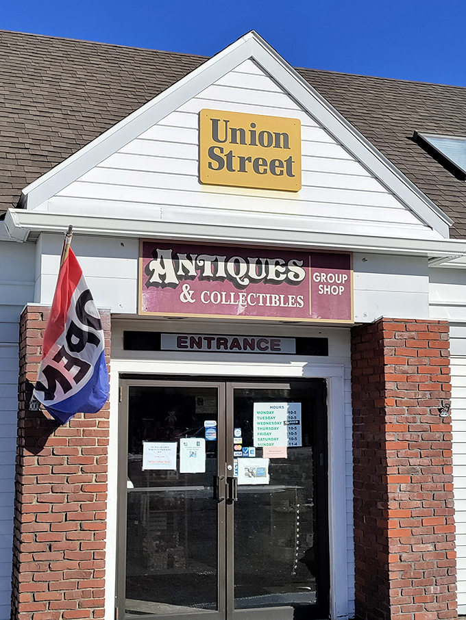The unassuming exterior of Union Street Antiques beckons with its yellow sign and classic New England charm—a time portal disguised as a simple white building.