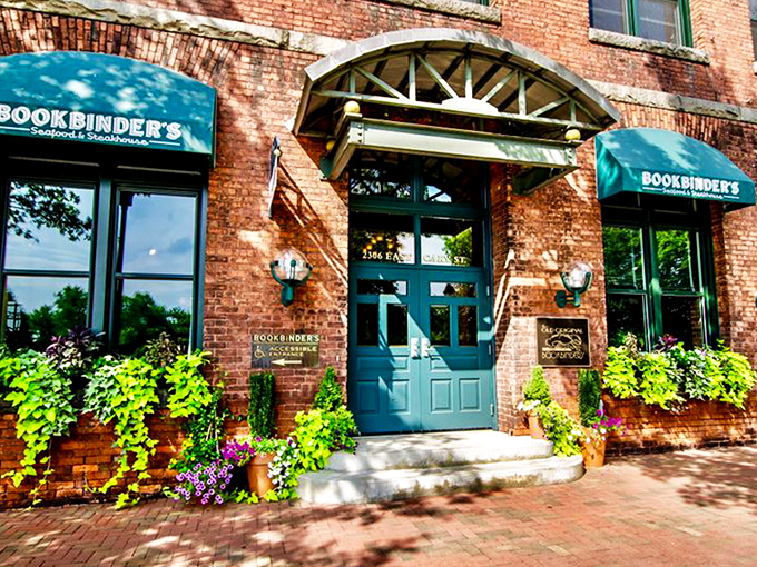 The historic brick façade of Bookbinder's welcomes you with teal awnings and warm globe lights—Richmond's culinary time machine disguised as a restaurant. 