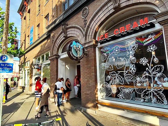 The architectural equivalent of "come hither" – Molly Moon's storefront beckons with its classic brick façade and neon glow, promising sweet relief from Seattle's bustling streets. 