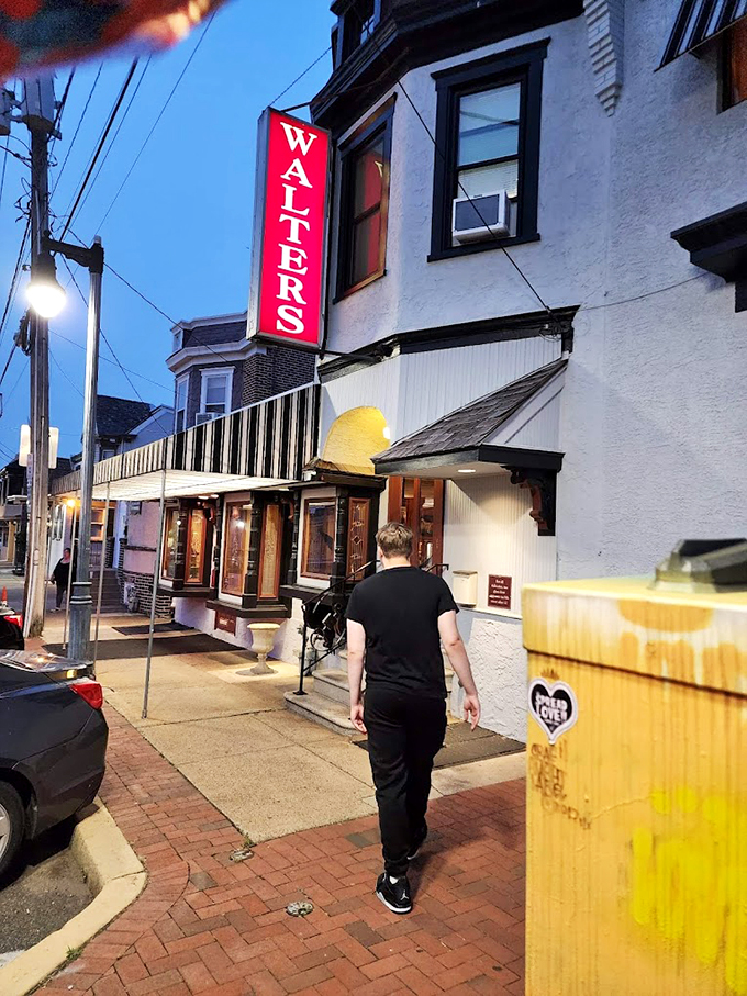 The iconic vertical WALTER'S sign beckons hungry carnivores like a meaty lighthouse guiding ships to safe harbor on Wilmington's brick-lined streets.