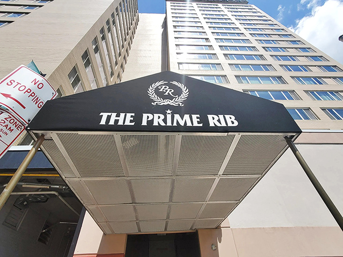 The understated elegance of The Prime Rib's entrance promises what lies beyond—a Baltimore dining institution where time stands deliciously still.