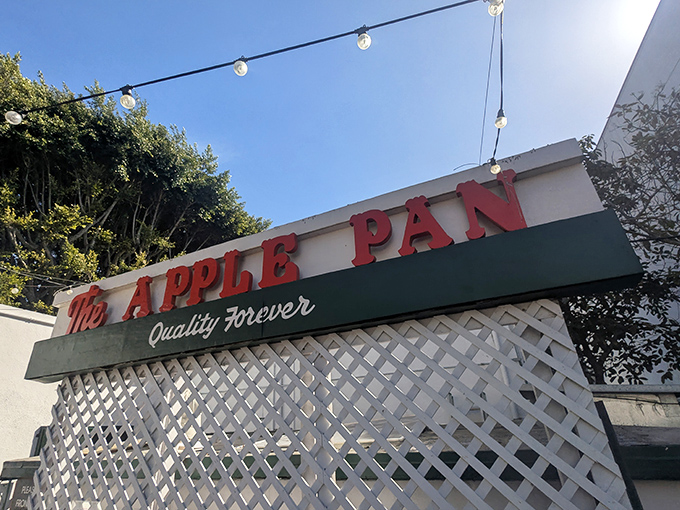The unassuming exterior of The Apple Pan stands like a time capsule amid modern LA, its vintage sign promising "Quality Forever" – a bold claim they've somehow managed to keep.