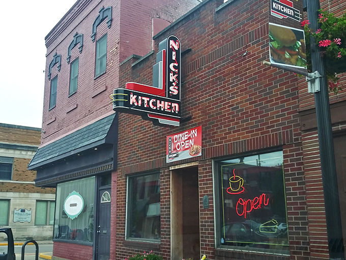 The iconic neon sign of Nick's Kitchen beckons like a lighthouse for hungry travelers in downtown Huntington. Comfort food paradise awaits!