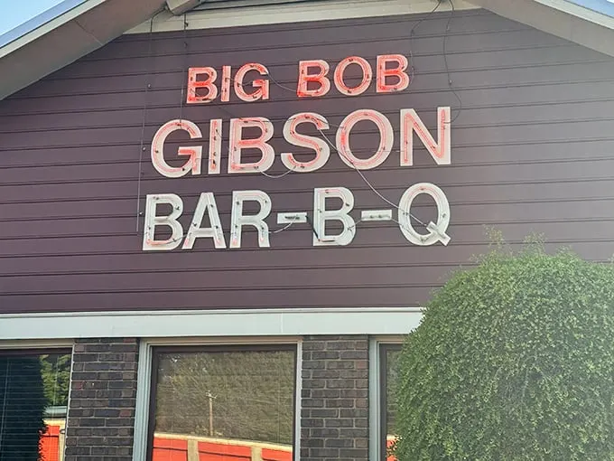The neon sign glows like a barbecue beacon, promising smoky salvation to hungry travelers. Big Bob Gibson's exterior says it all: serious barbecue happens here.